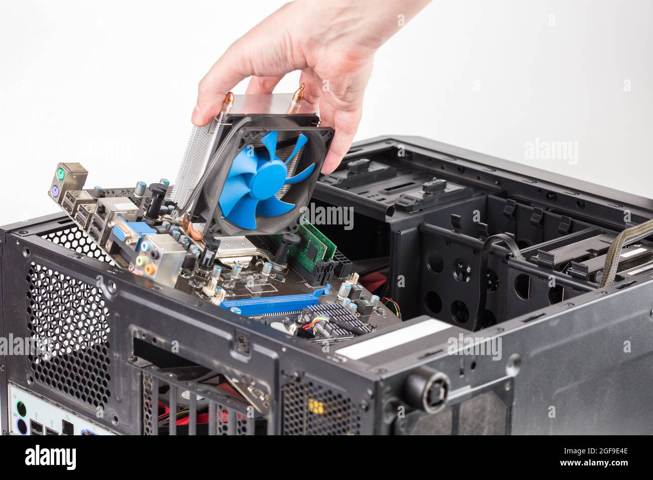 hand putting in or removing pc internals - motherboard with attached ... hand putting in or removing pc internals - motherboard with attached ...