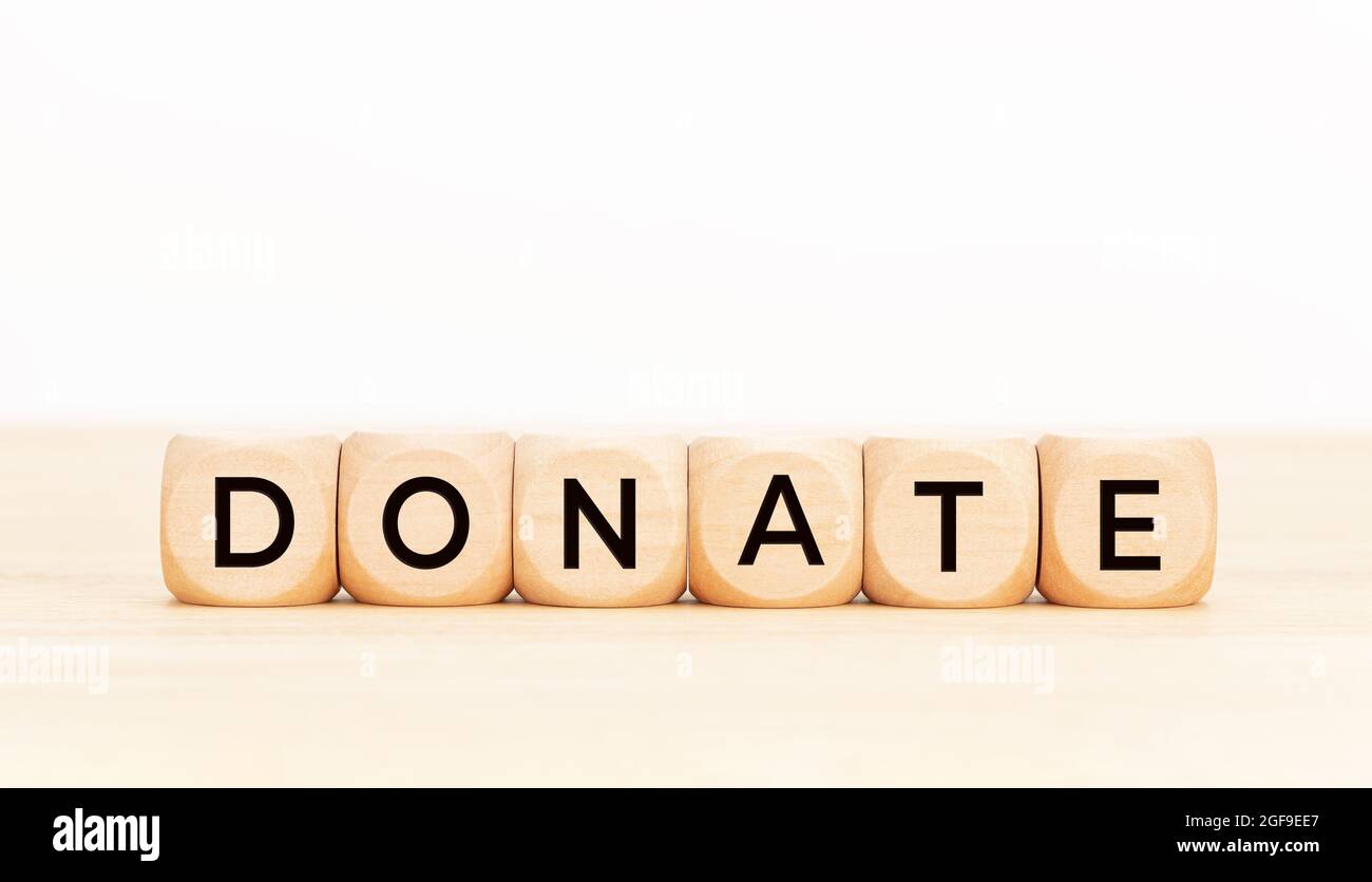 Donation word on wooden block shape. Copy space. White background Stock ...