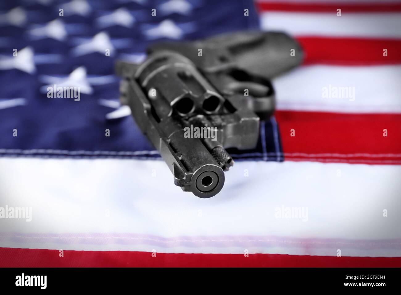 Gun on background of USA flag Stock Photo - Alamy