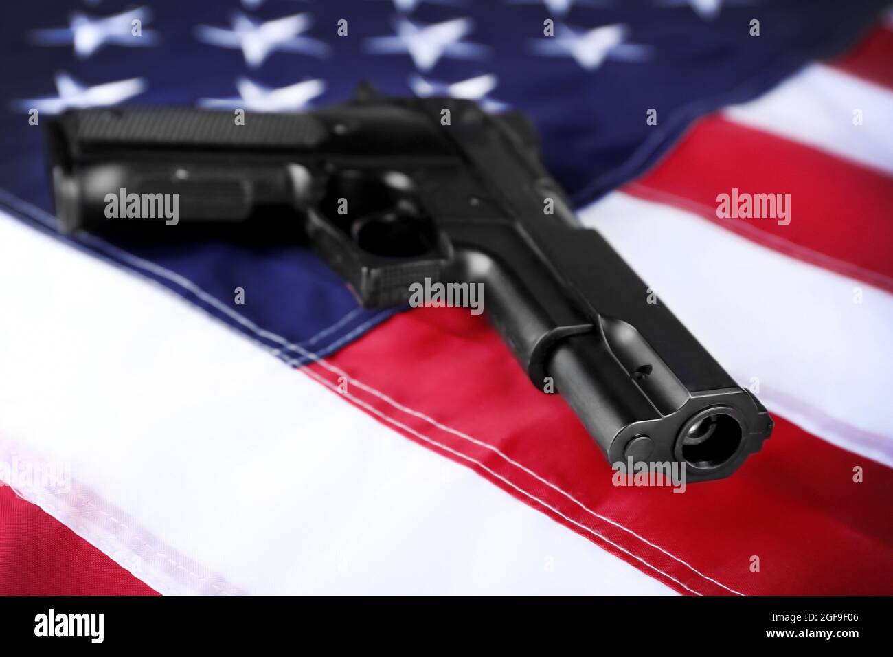 Gun on background of USA flag Stock Photo - Alamy