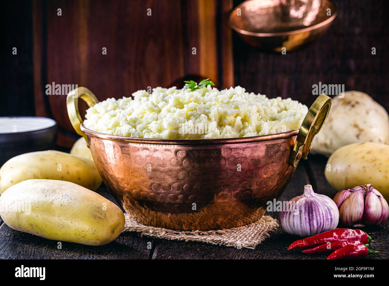mashed potato, potato cream in rustic kitchen, in rustic copper pot ...