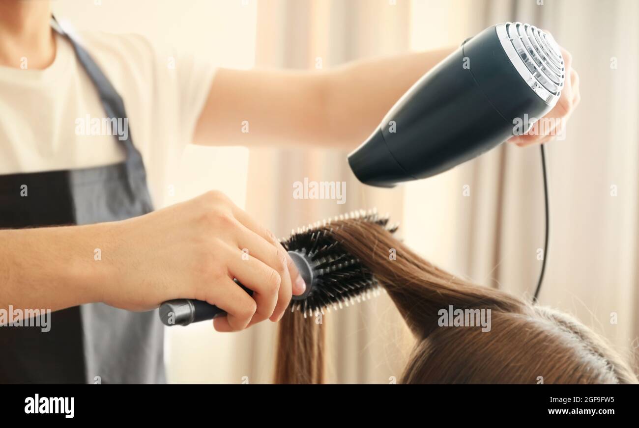 Professional hairdresser drying hair Stock Photo - Alamy