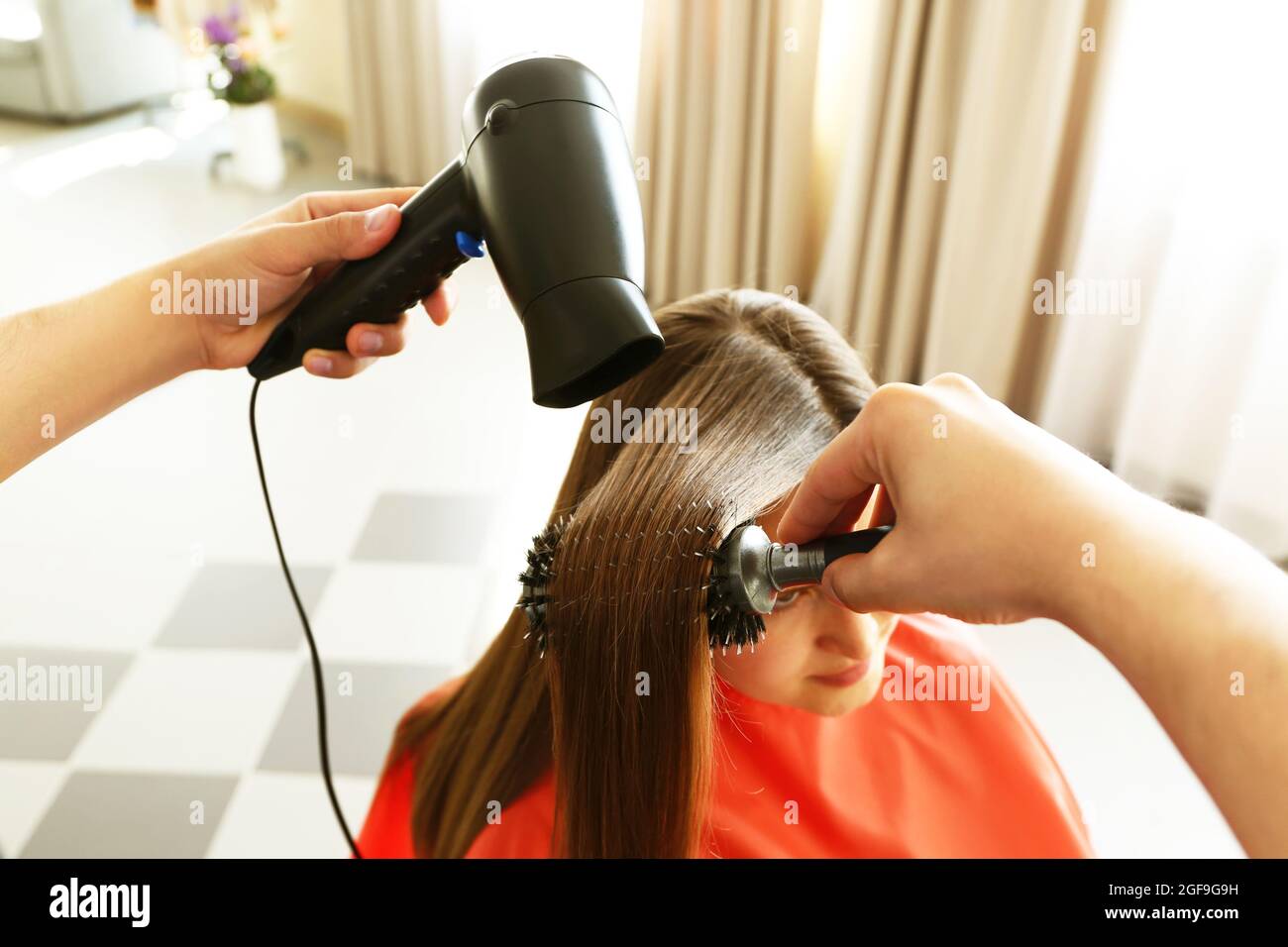 Professional hairdresser drying hair Stock Photo - Alamy