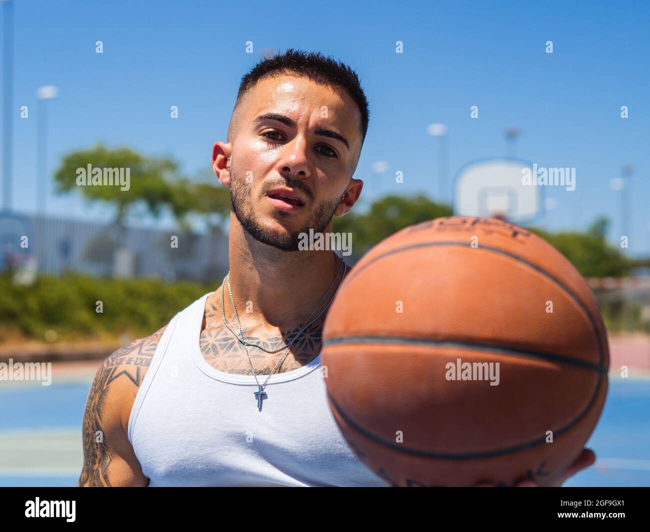 Athletic handsome Spanish basketball player training on basketball ...