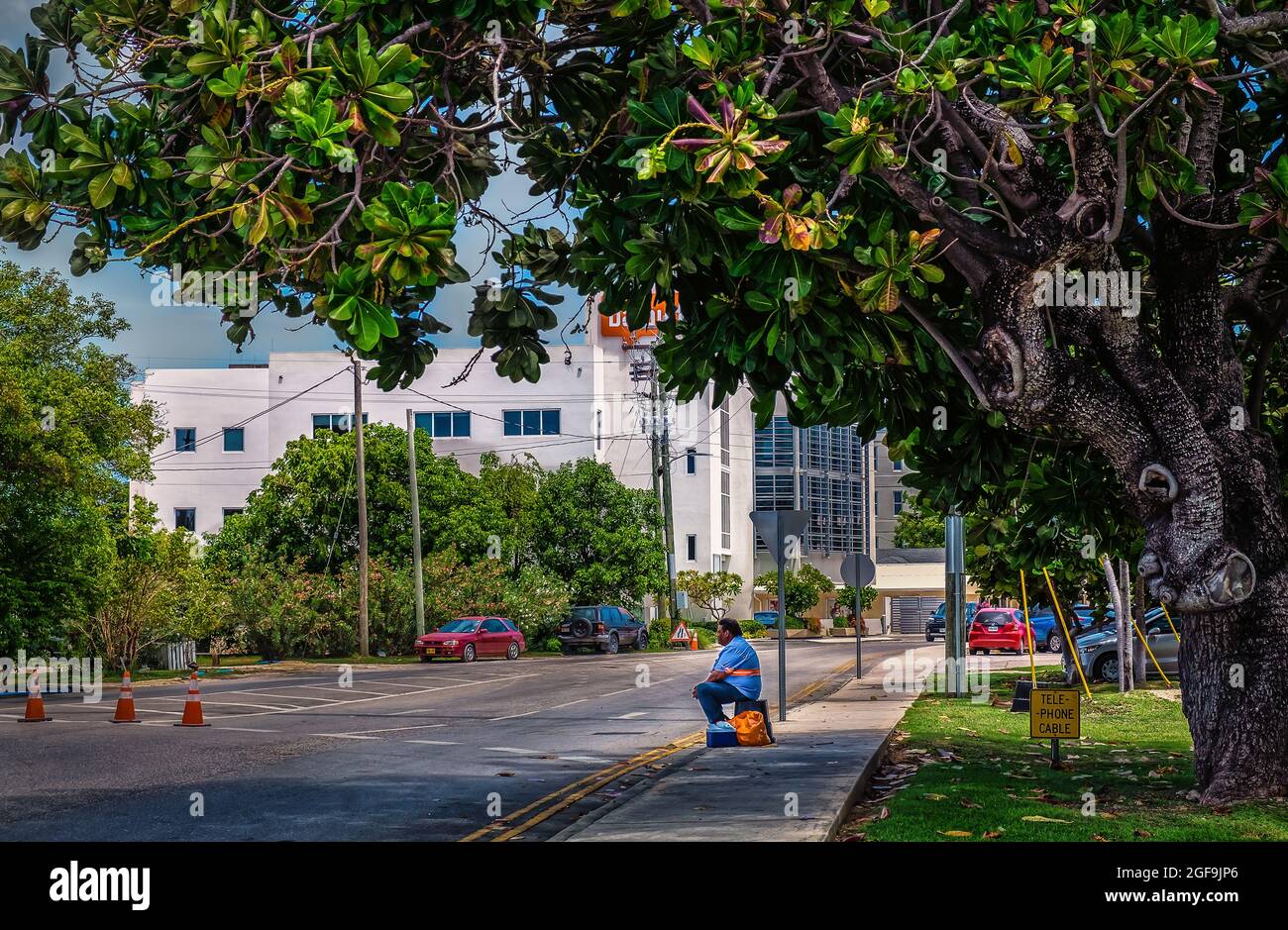 Grand Cayman, Cayman Islands, July 2020, view of a man sitting and ...