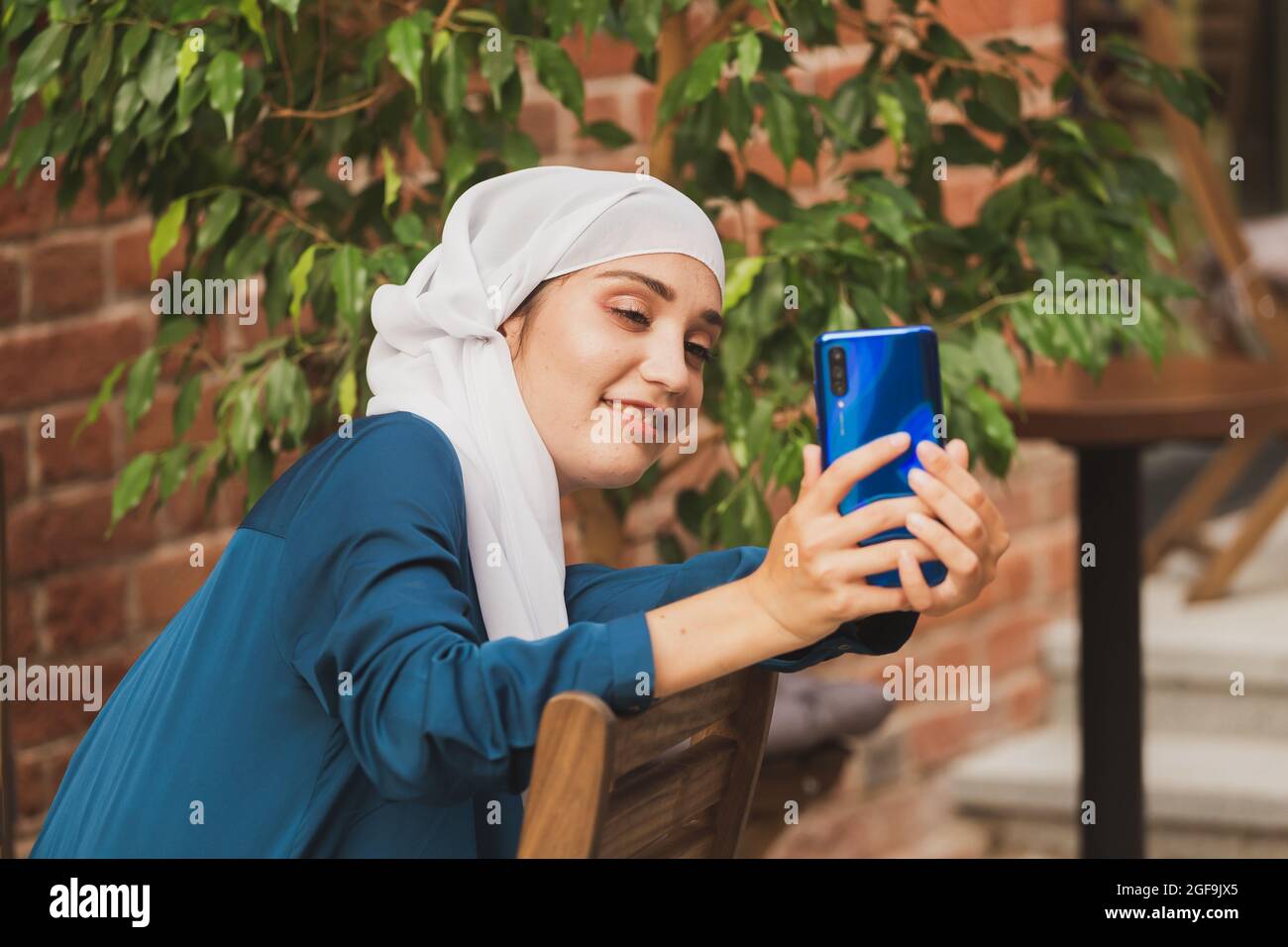 Muslim woman taking selfie. Happy beautiful girl with scarf take ...