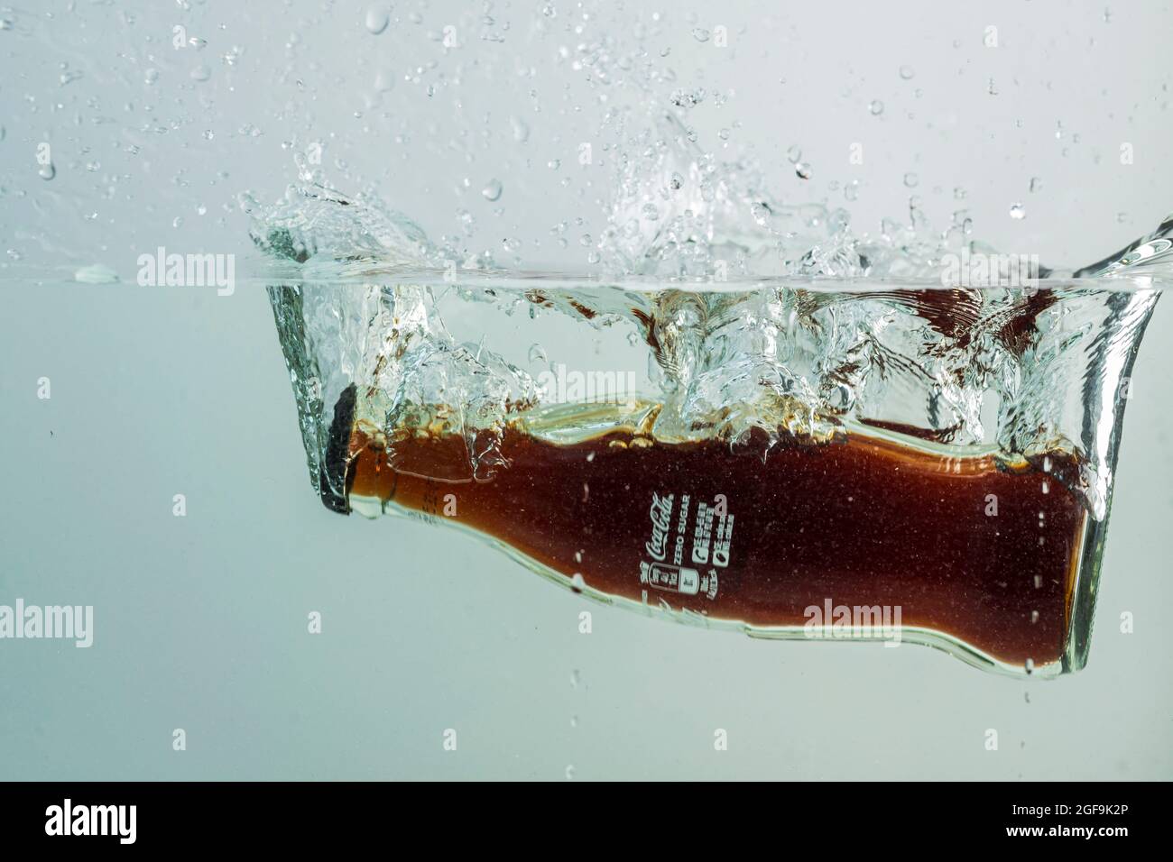 Close up view of Coca cola bottle falling in water Stock Photo - Alamy