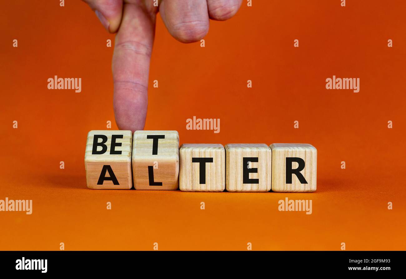 Alter or better symbol. Businessman turns wooden cubes and changes the ...