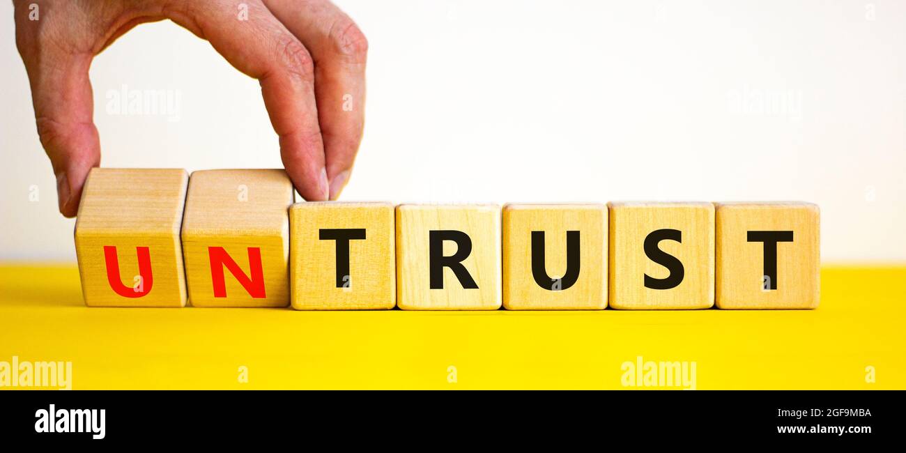 Untrust or trust symbol. Businessman turns wooden cubes, changes words ...