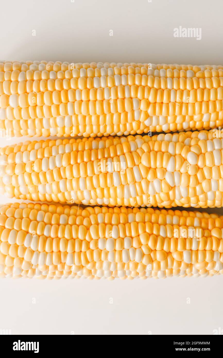 Fresh corn on cob with husk on white, flat lay, top view. Vegan food, agriculture Stock Photo ...