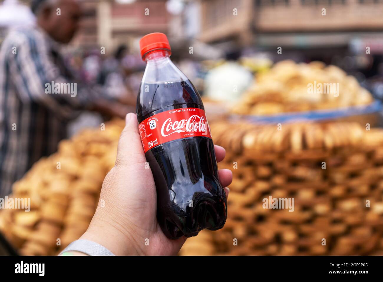 Mandawa, India - 28 February, 2018: Hand holding bottle of mini Coca ...