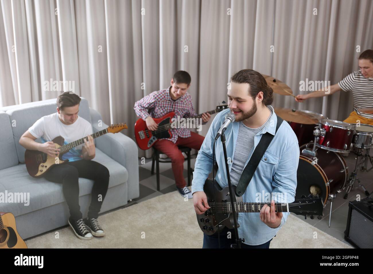 Music band performing in a recording studio Stock Photo - Alamy