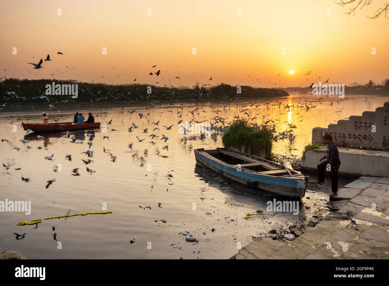 New Delhi, India - March 04, 2018: Man near the boat at Yamuna river ...