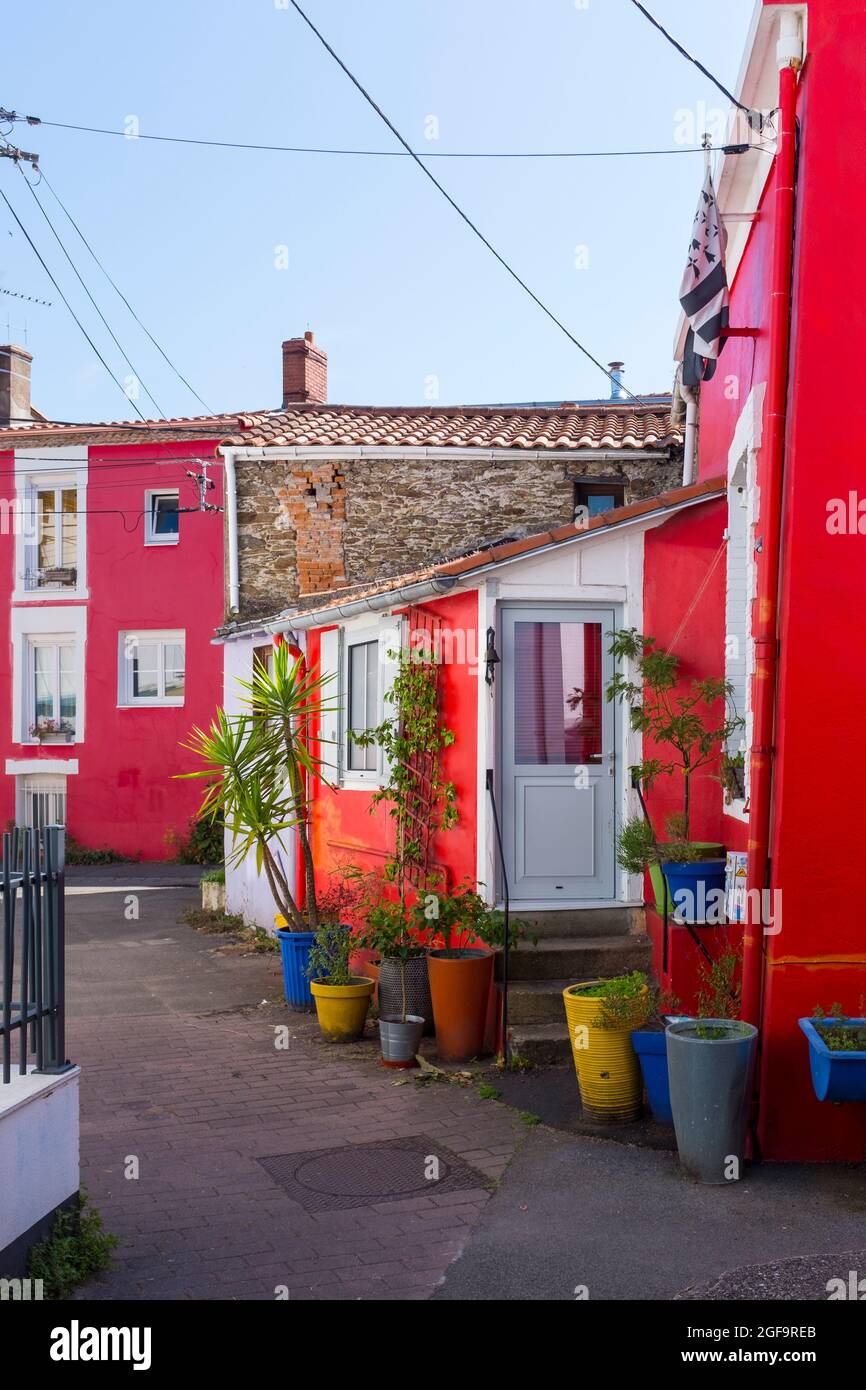 Colorful bright red painted houses on the narrow backstreets of the old ...