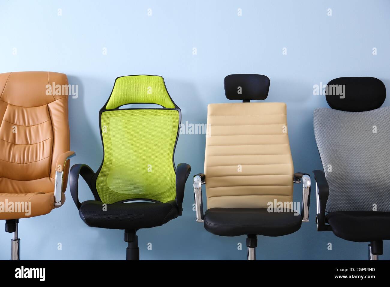 New office chairs on wall background Stock Photo - Alamy