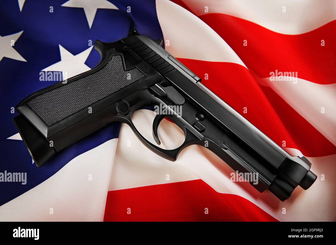 Gun on USA flag background Stock Photo - Alamy