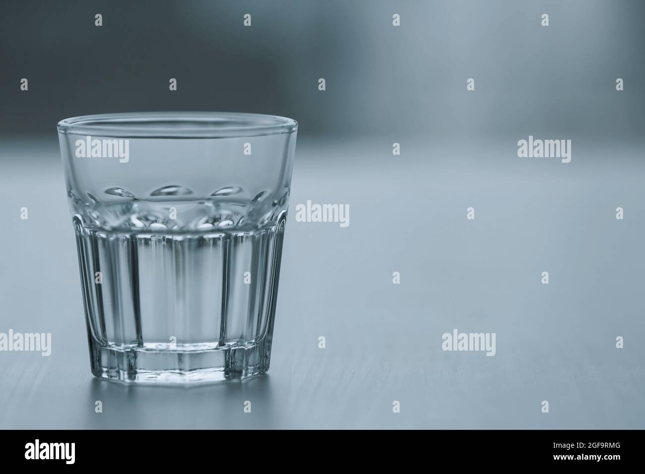 Glass of pure water on blurred background Stock Photo - Alamy