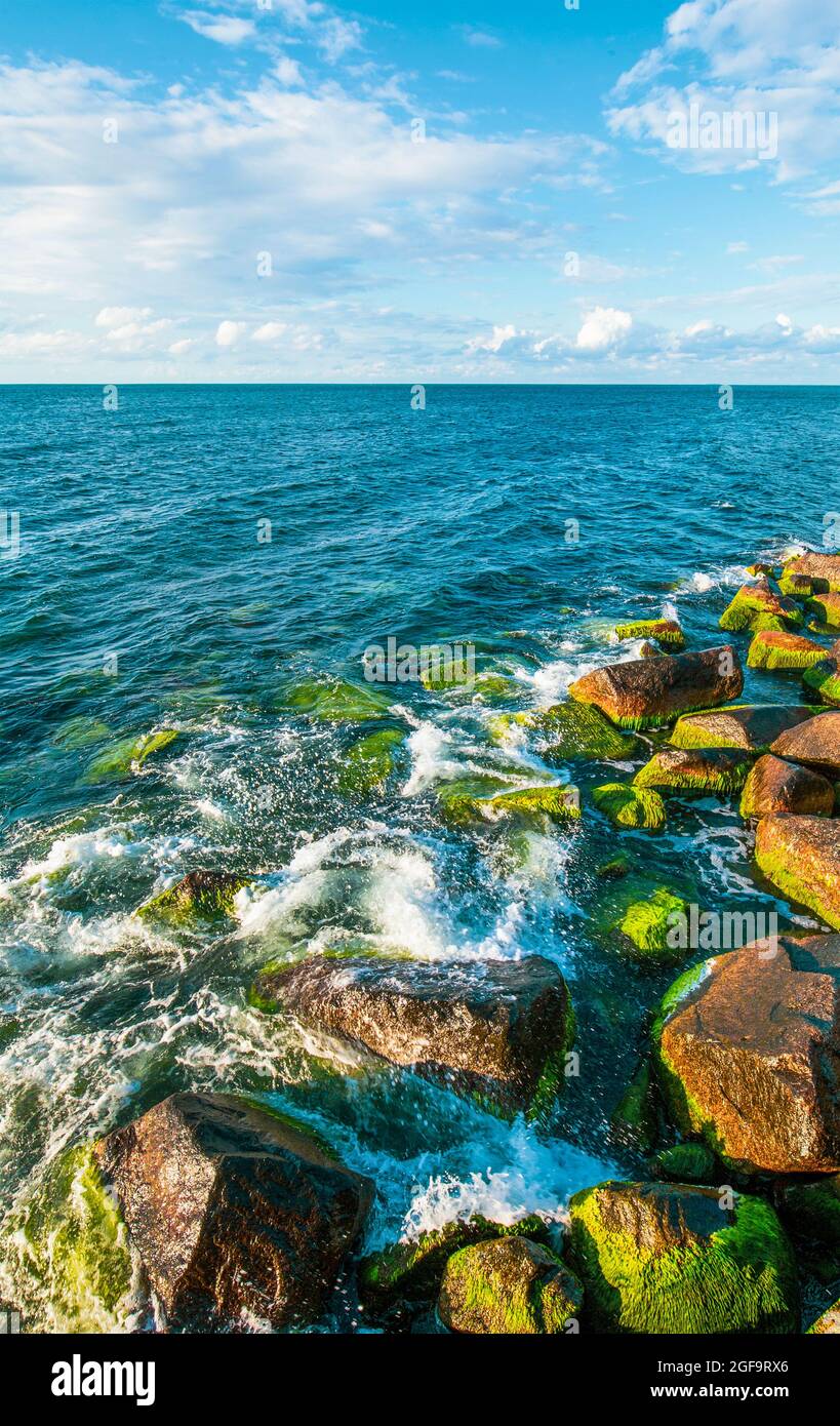 Colorful rock formation in the sea around picturesque small town ...