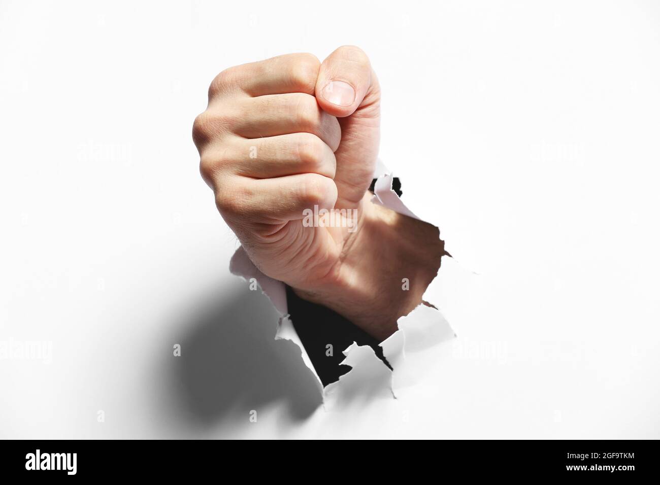 Fist punching through paper hi-res stock photography and images - Alamy