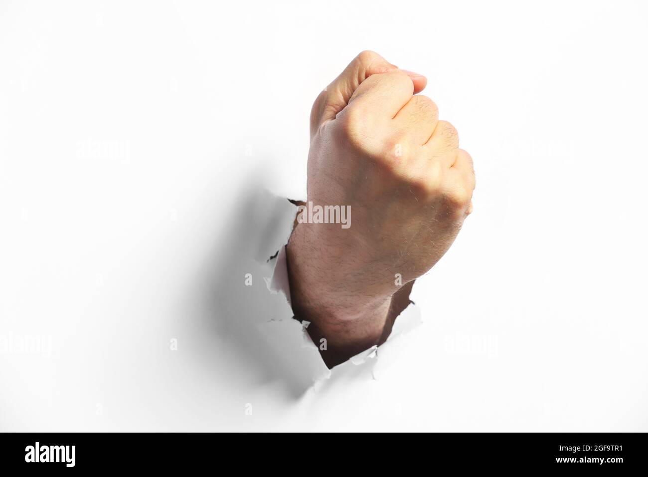 Fist punching through paper hi-res stock photography and images - Alamy