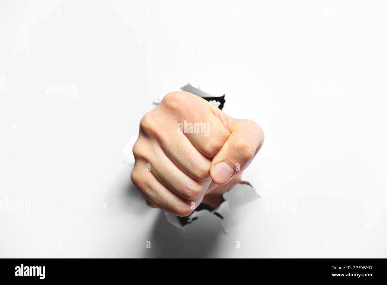 Hand Punching Through White Paper High Resolution Stock Photography and ...