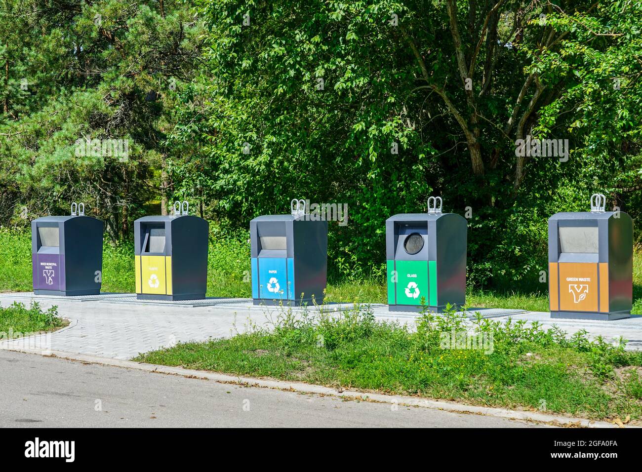 five different waste sorting containers on a city street Stock Photo ...