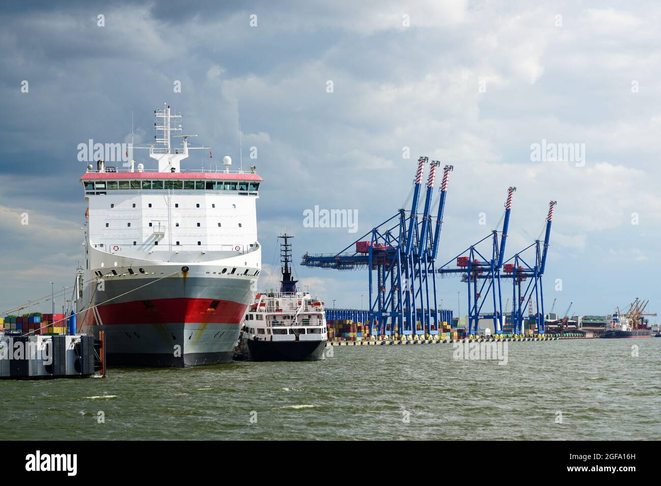 wide view of the port with a sea container terminal, loading cranes and ...