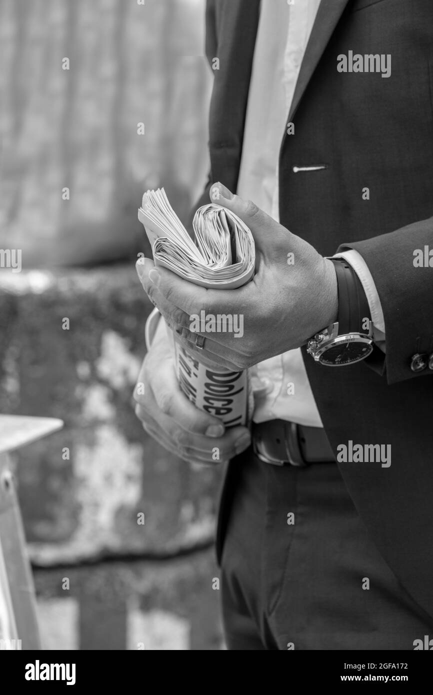 Part view of a man having a newspaper in the hands, in black and white ...