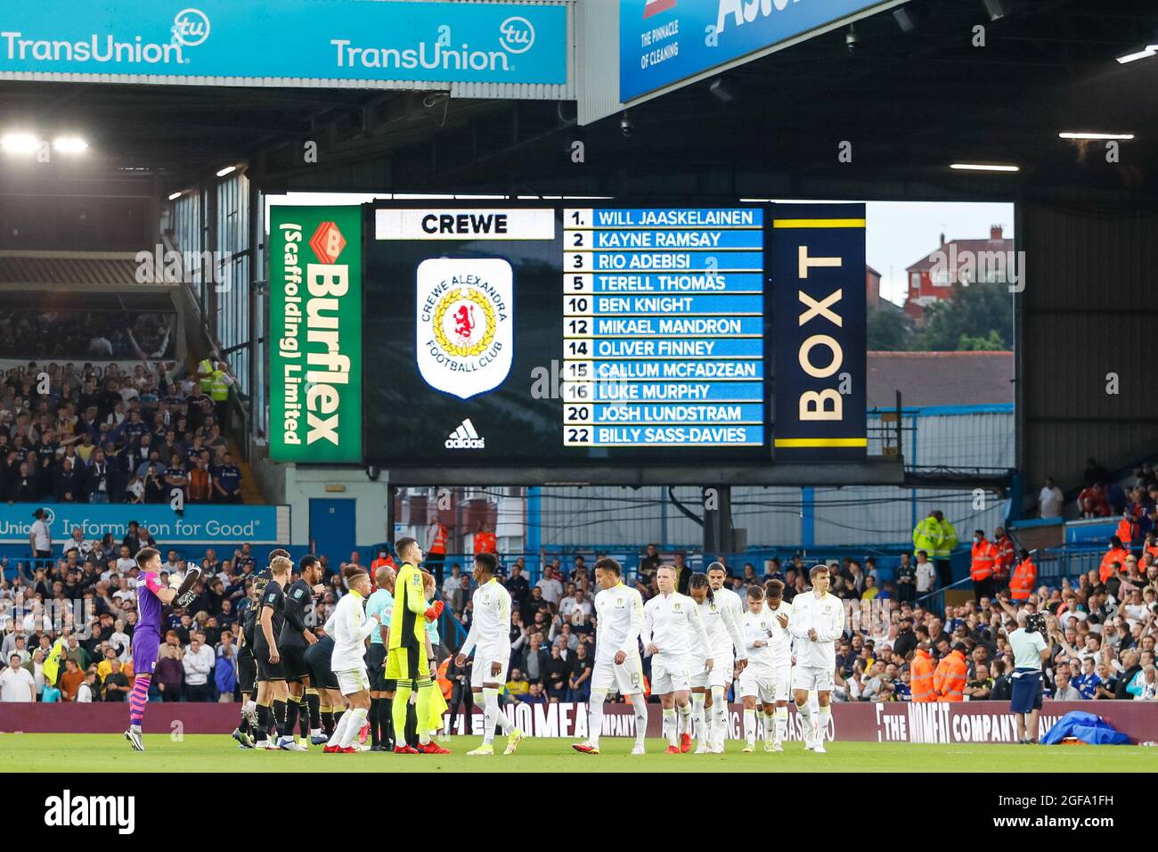 Both teams walk out onto the pitch for the start of the game Stock ...
