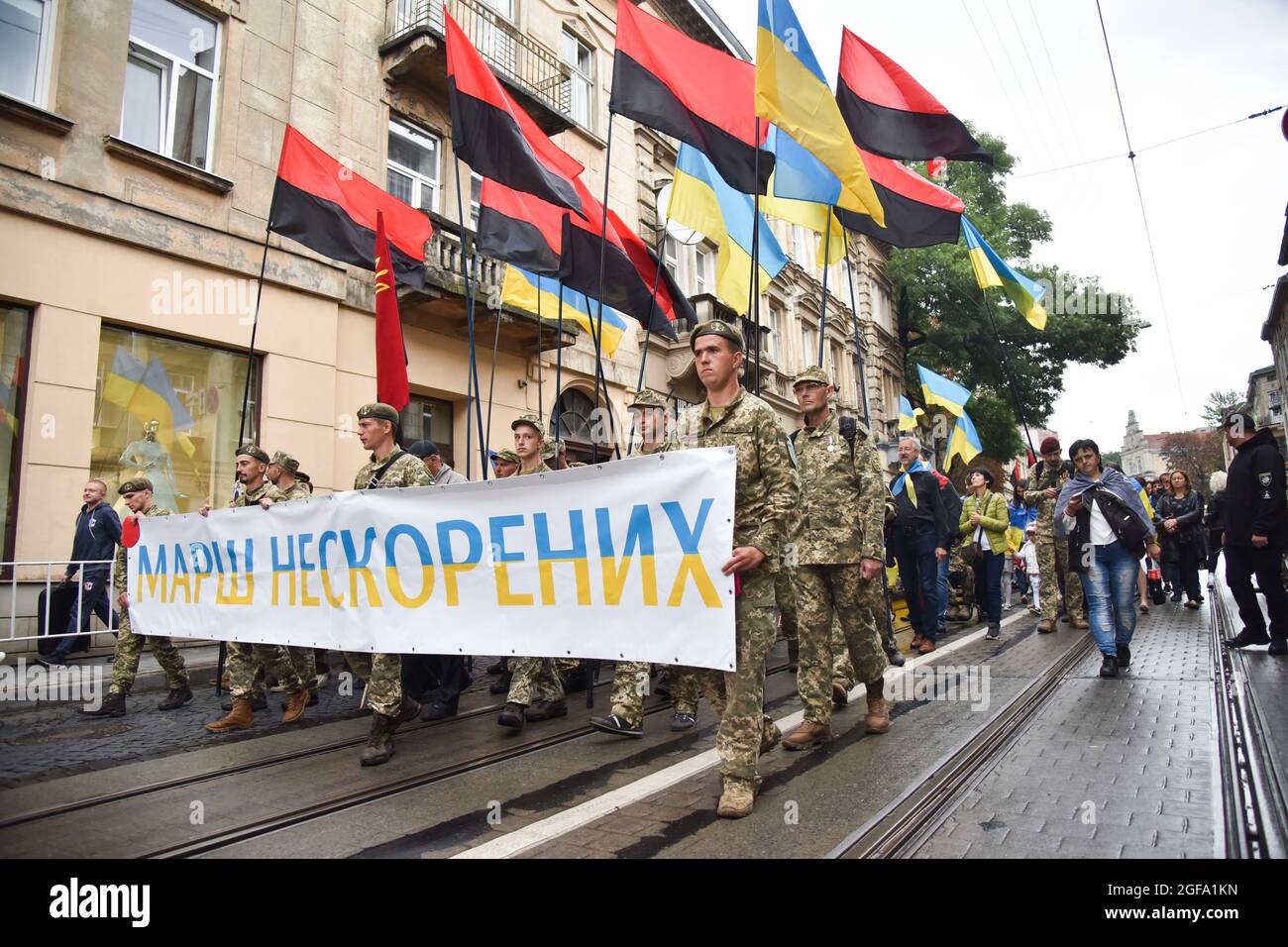 Lviv, Ukraine. 24th Aug, 2021. Soldiers carry a banner reading "March ...