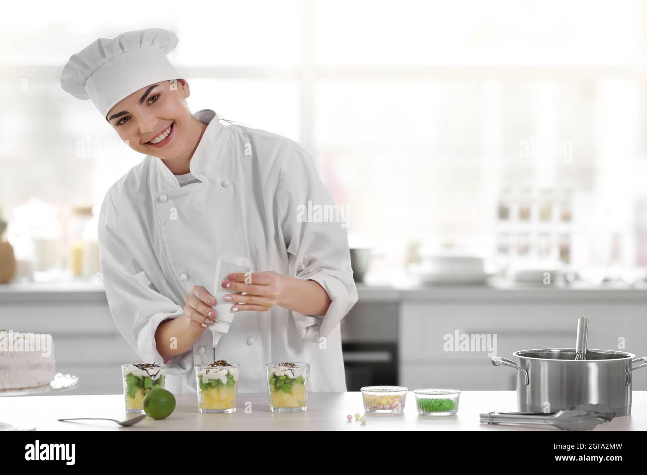 Professional confectioner cooking delicious dessert at kitchen Stock ...