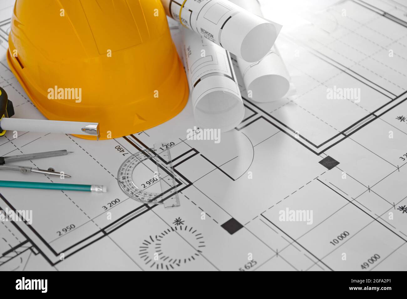 Construction blueprints with tools and helmet closeup Stock Photo - Alamy