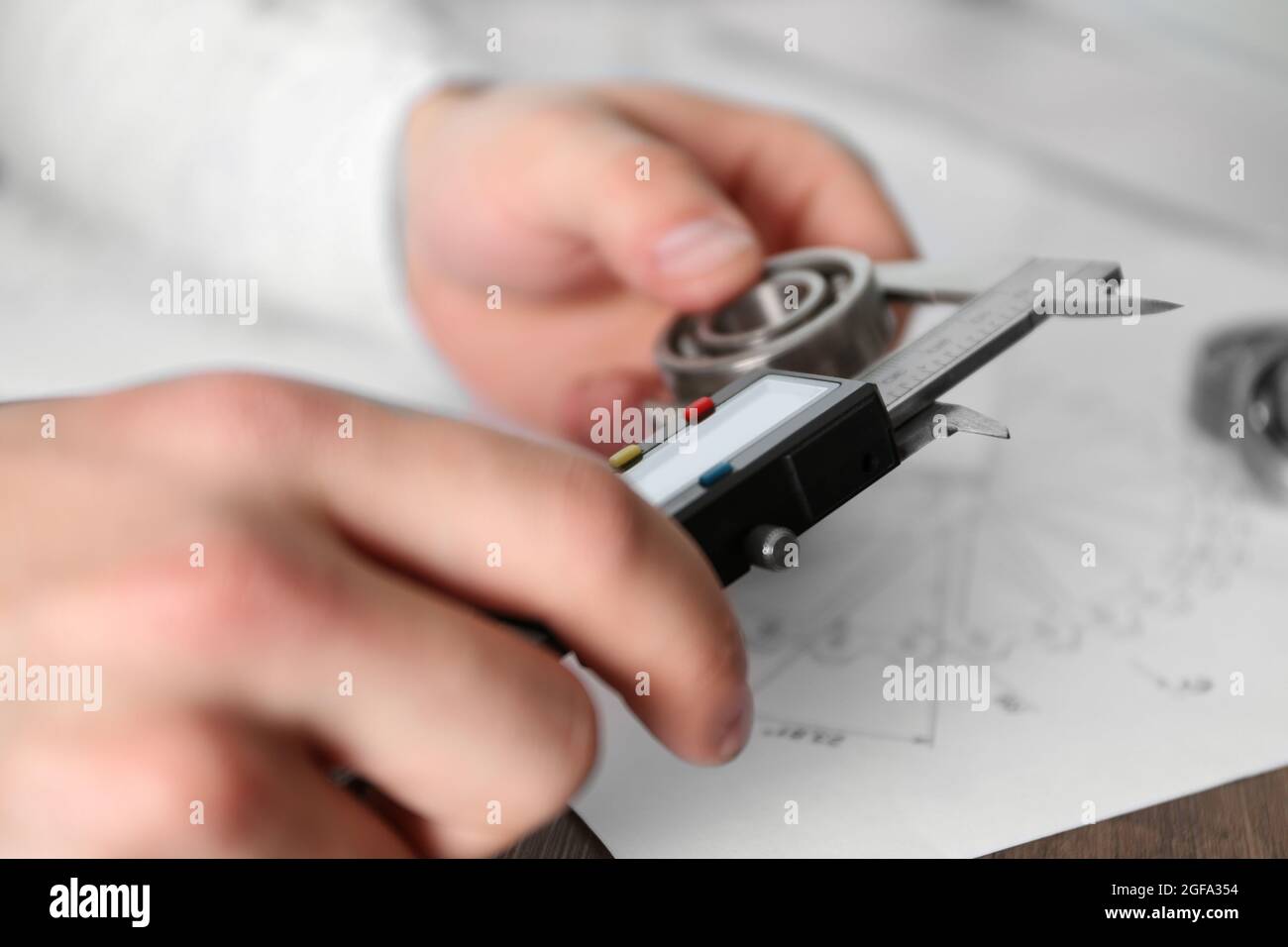 Male hands measuring metal detail closeup Stock Photo - Alamy