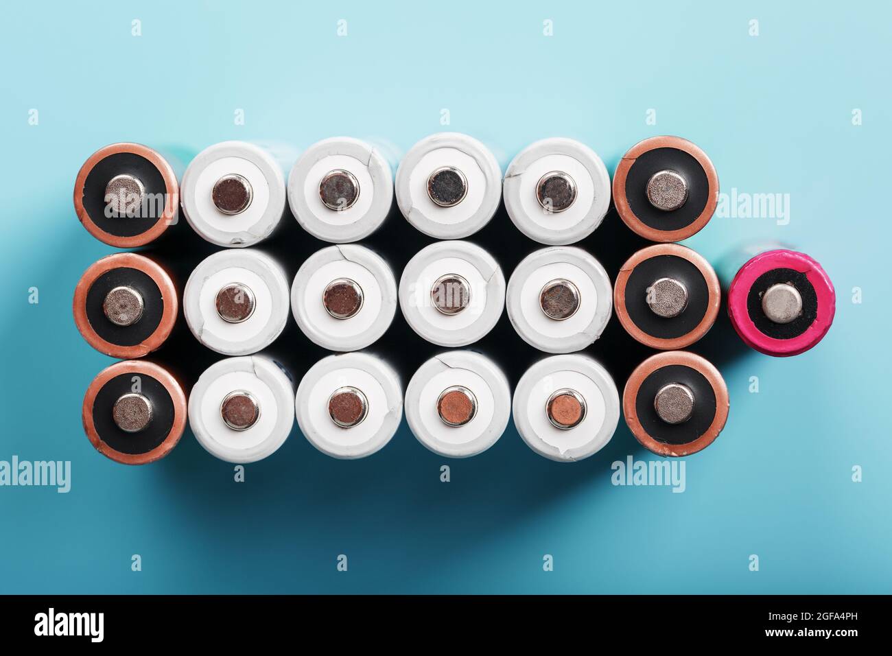 AA batteries are arranged in the form of a large battery on a blue ...