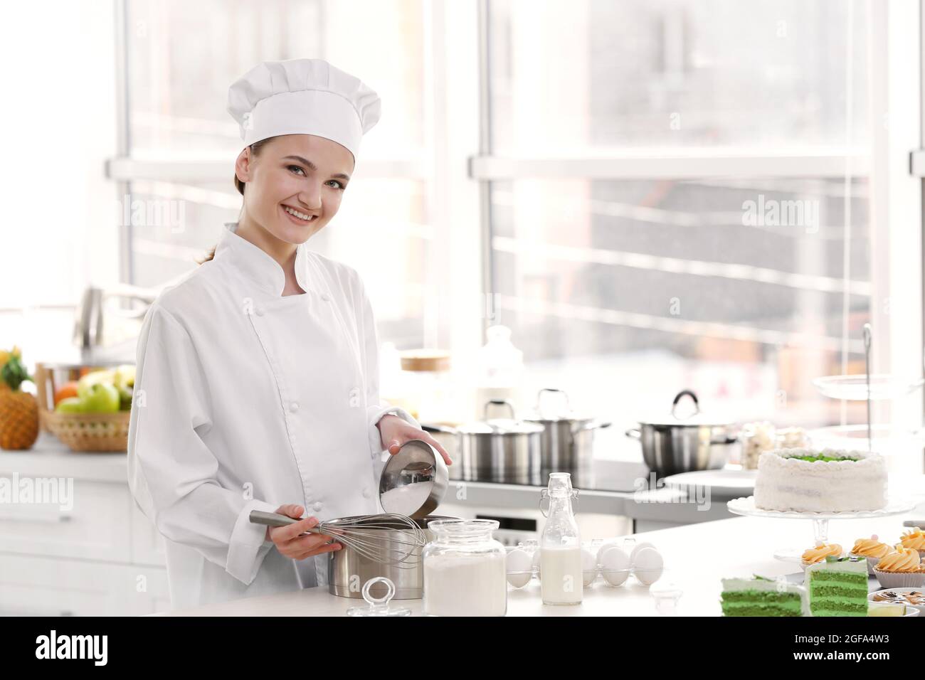 Female chef working at kitchen Stock Photo - Alamy