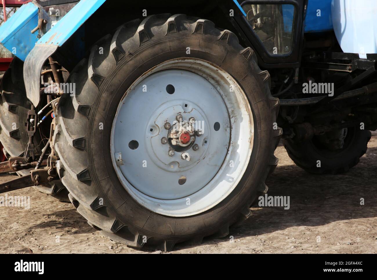 Wheel of a blue tractor, close up Stock Photo - Alamy