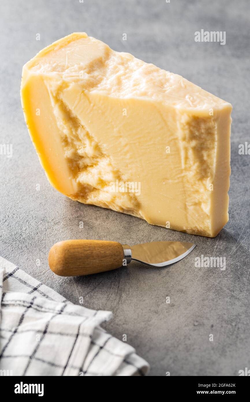 Block of italian parmesan cheese on kitchen table Stock Photo - Alamy