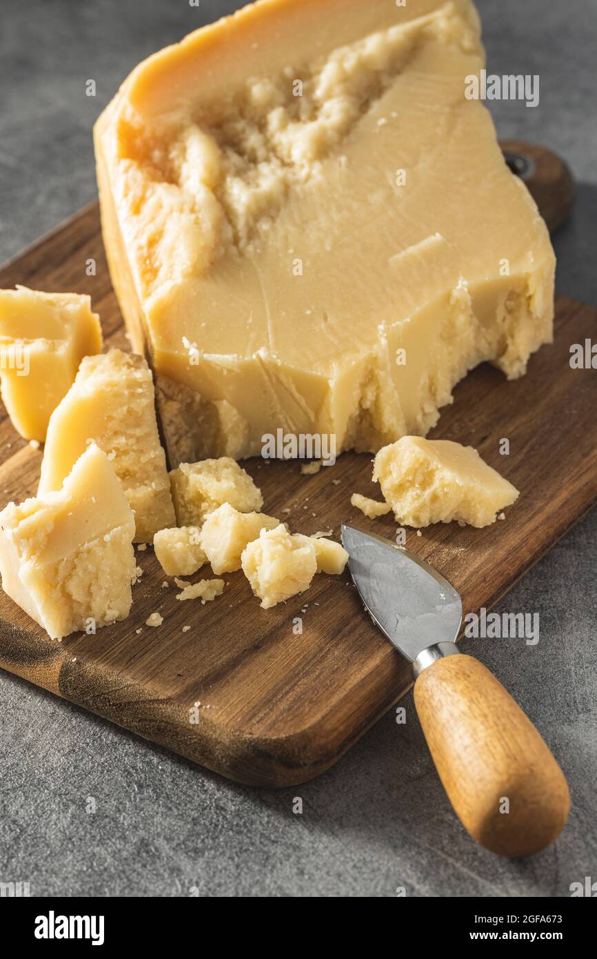 Pieces of italian parmesan cheese. Block of parmesan on kitchen table ...