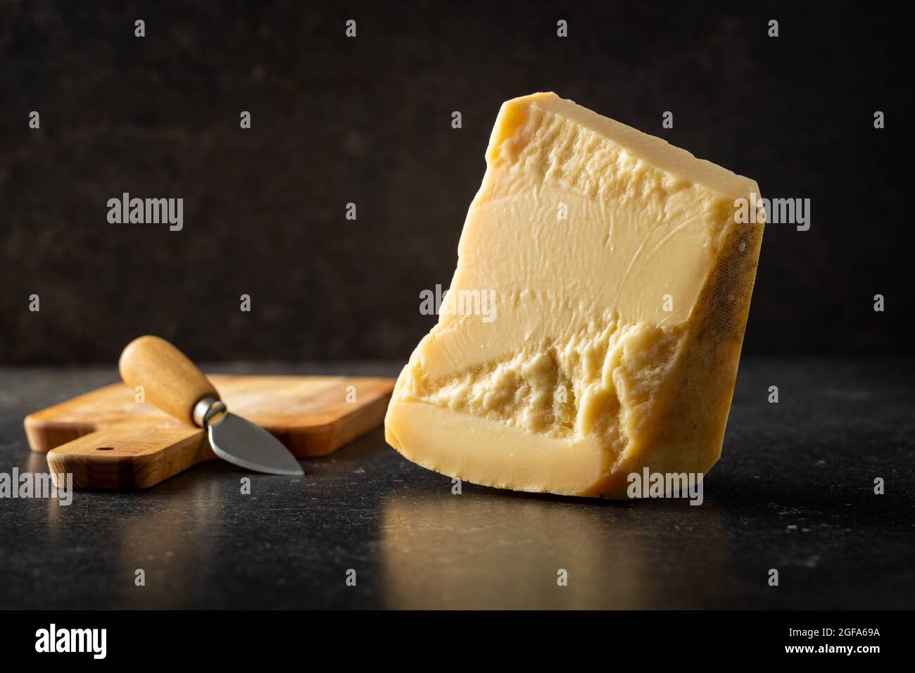 Block of italian parmesan cheese on kitchen table Stock Photo - Alamy