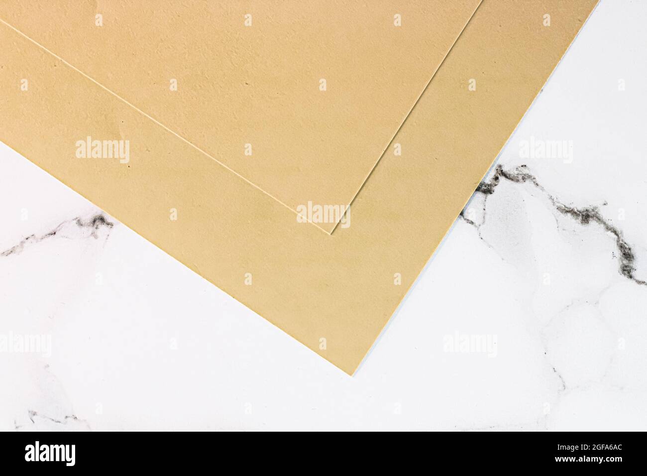 Beige A4 papers on white marble background as office stationery flatlay ...