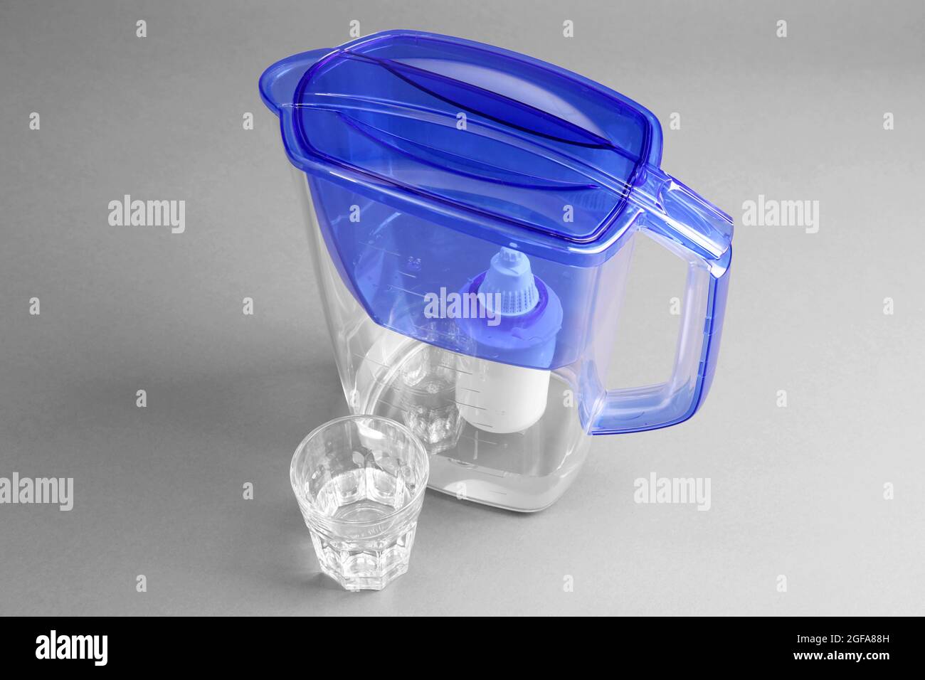 Water filter jug and a glass on the grey background Stock Photo - Alamy