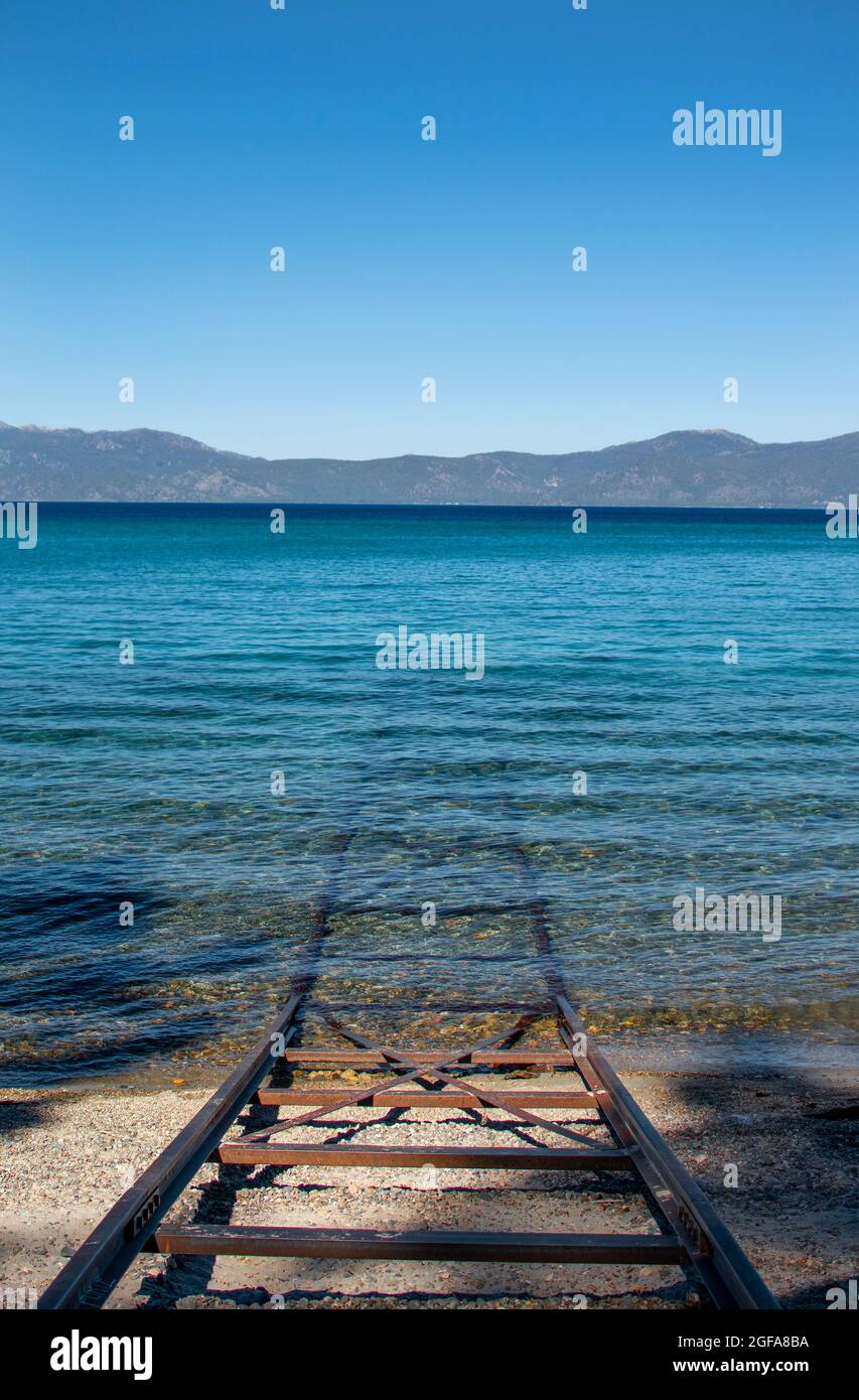 Old railroad leading into the water Stock Photo - Alamy