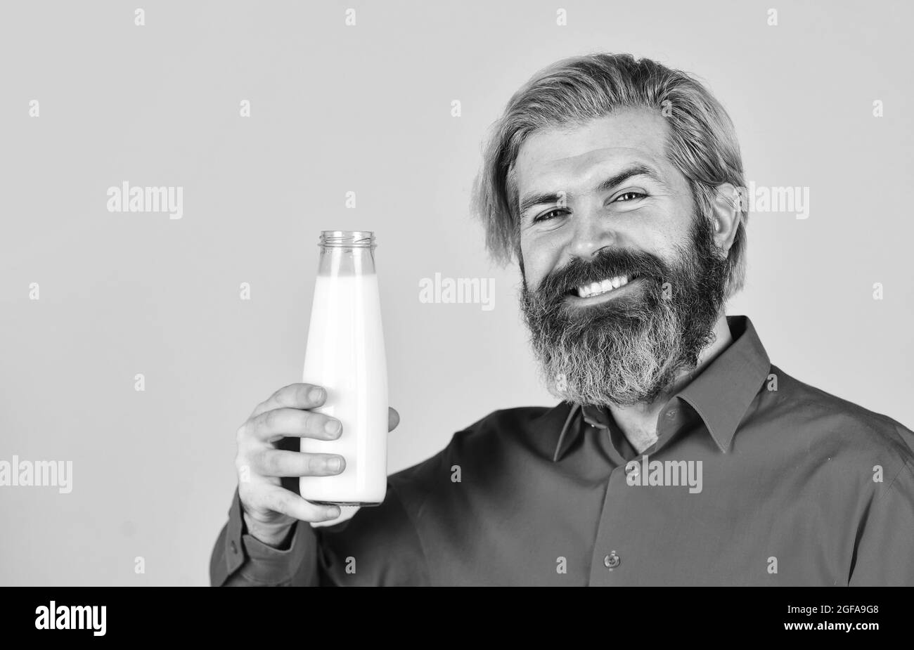 How to be dairy free. Lactose intolerance. Bearded man hold milk bottle ...