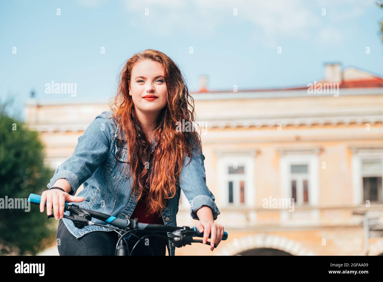 Half-length portrait of long red curly hair caucasian teenager girl ...
