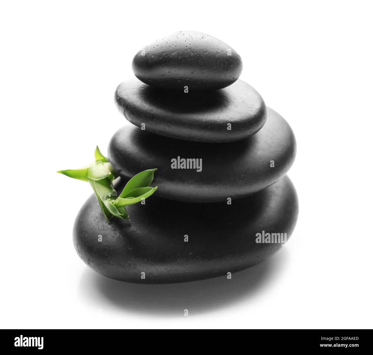 Stack of spa hot stones isolated on white background Stock Photo - Alamy