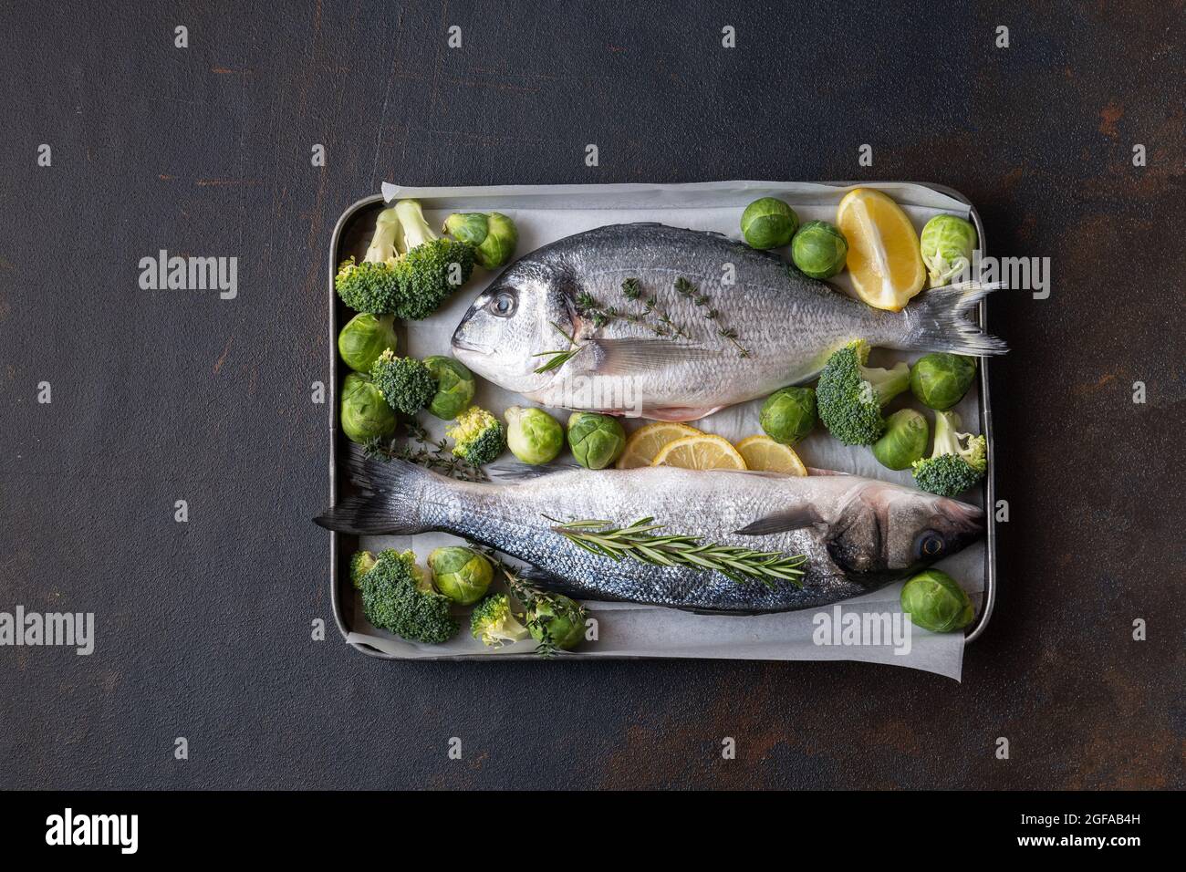 Fresh raw dorado and sibas fish with spices. Ingredients for cooking or ...