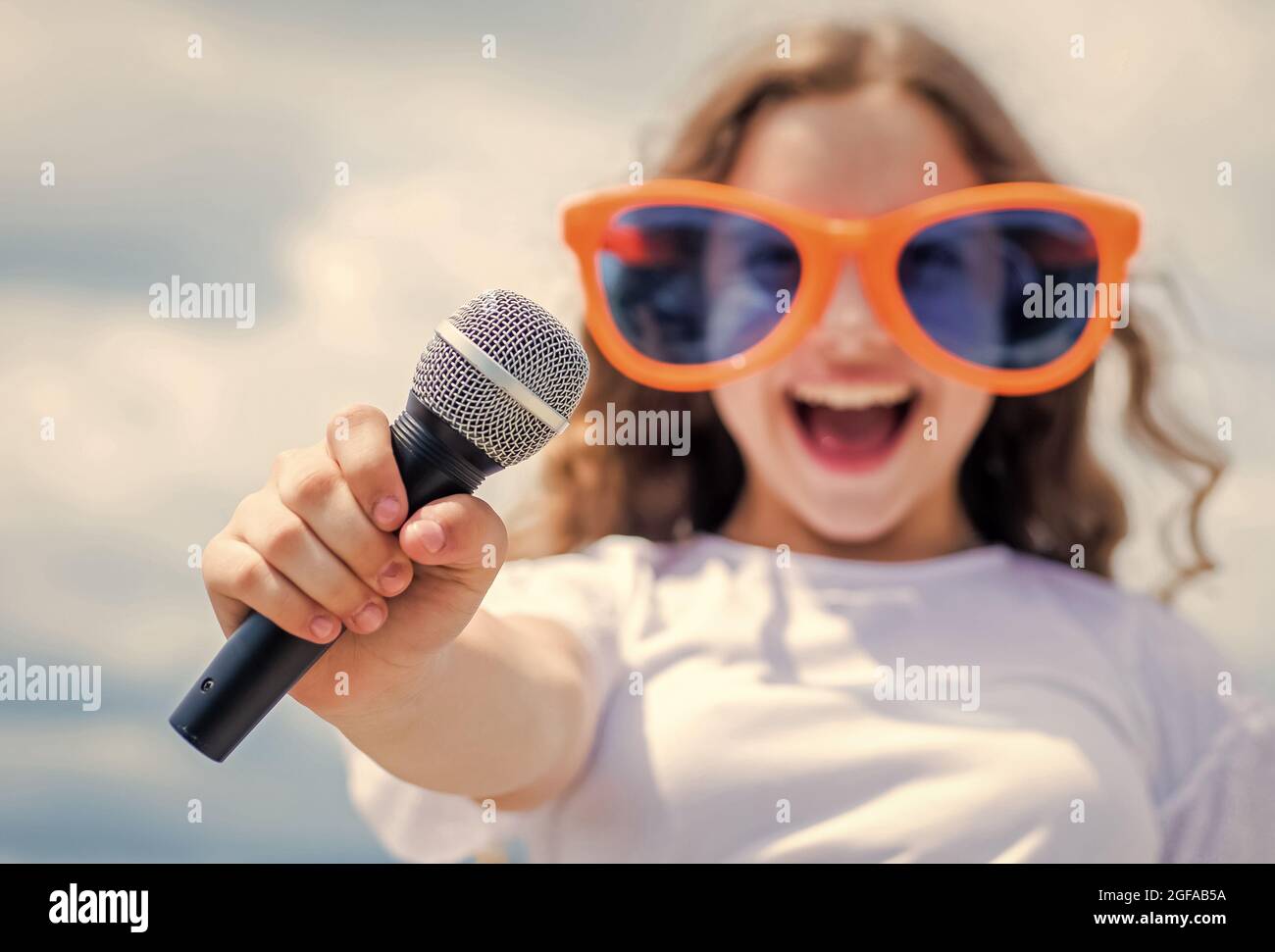 kid sing with mic. cheerful event manager. child have fun on party ...