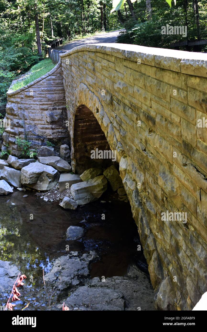 Stone CCC bridge arching over a creek at McCormick's Creek State Park ...