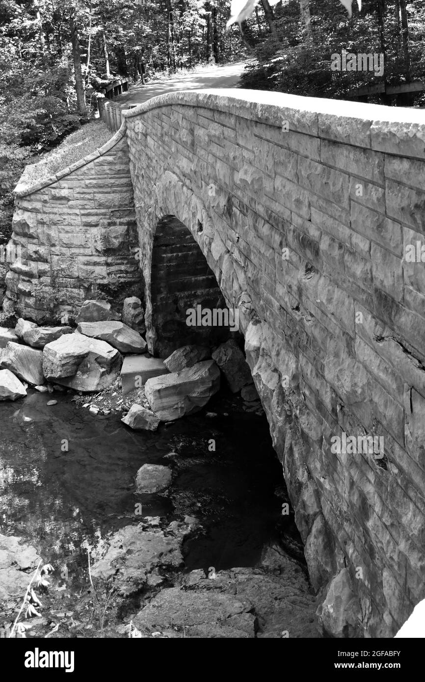 Stone CCC bridge arching over a creek at McCormick's Creek State Park ...