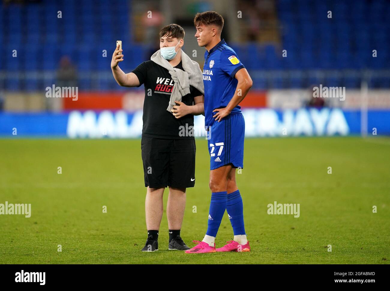 Pitch invader takes selfie with Cardiff City's Rubin Colwill during the ...